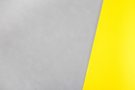 Diagonal with yellow paper and gray concrete texture, blank background ...