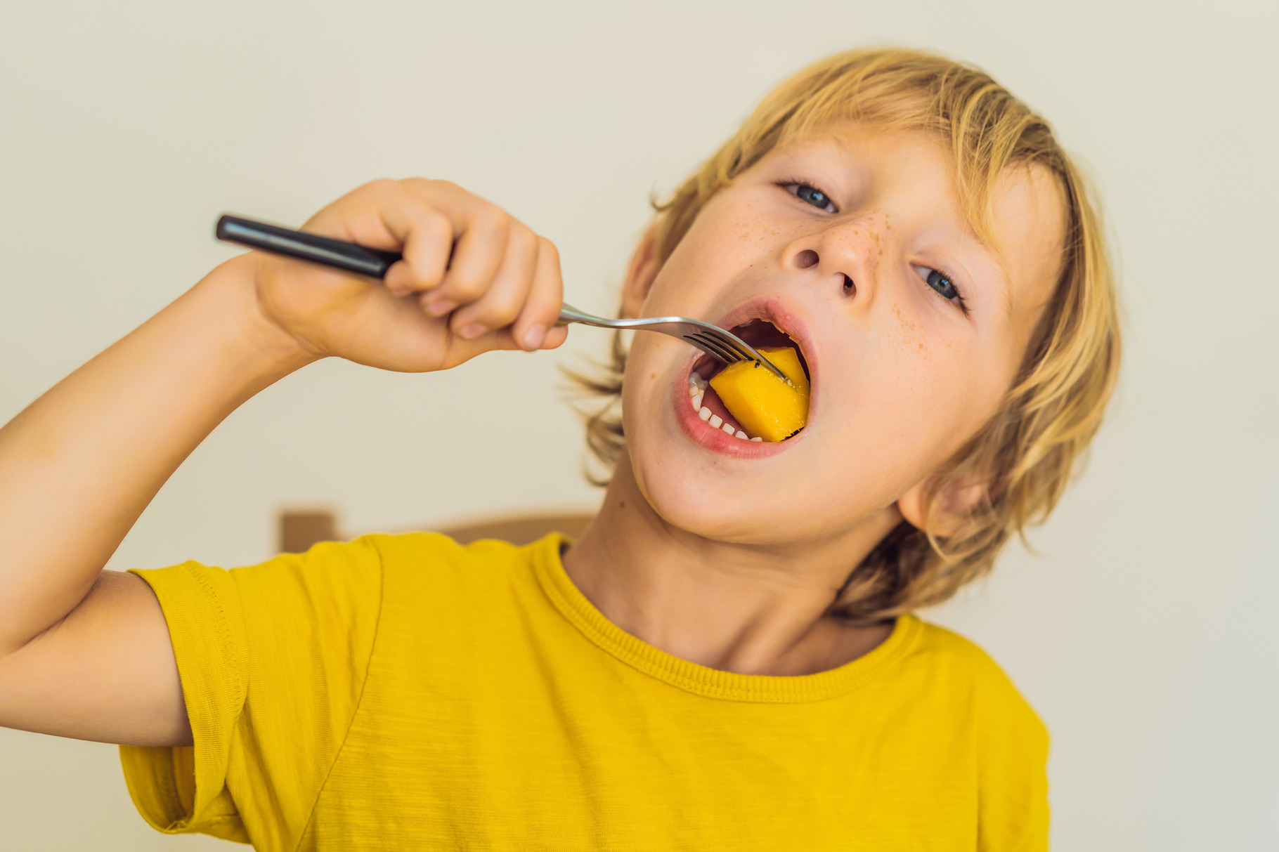 Boy eats fruit healthy food for featuring food, healthy, and fruit, a ...