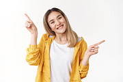 Happy asian girl pointing left right, a Person Photo by Cookie Studio