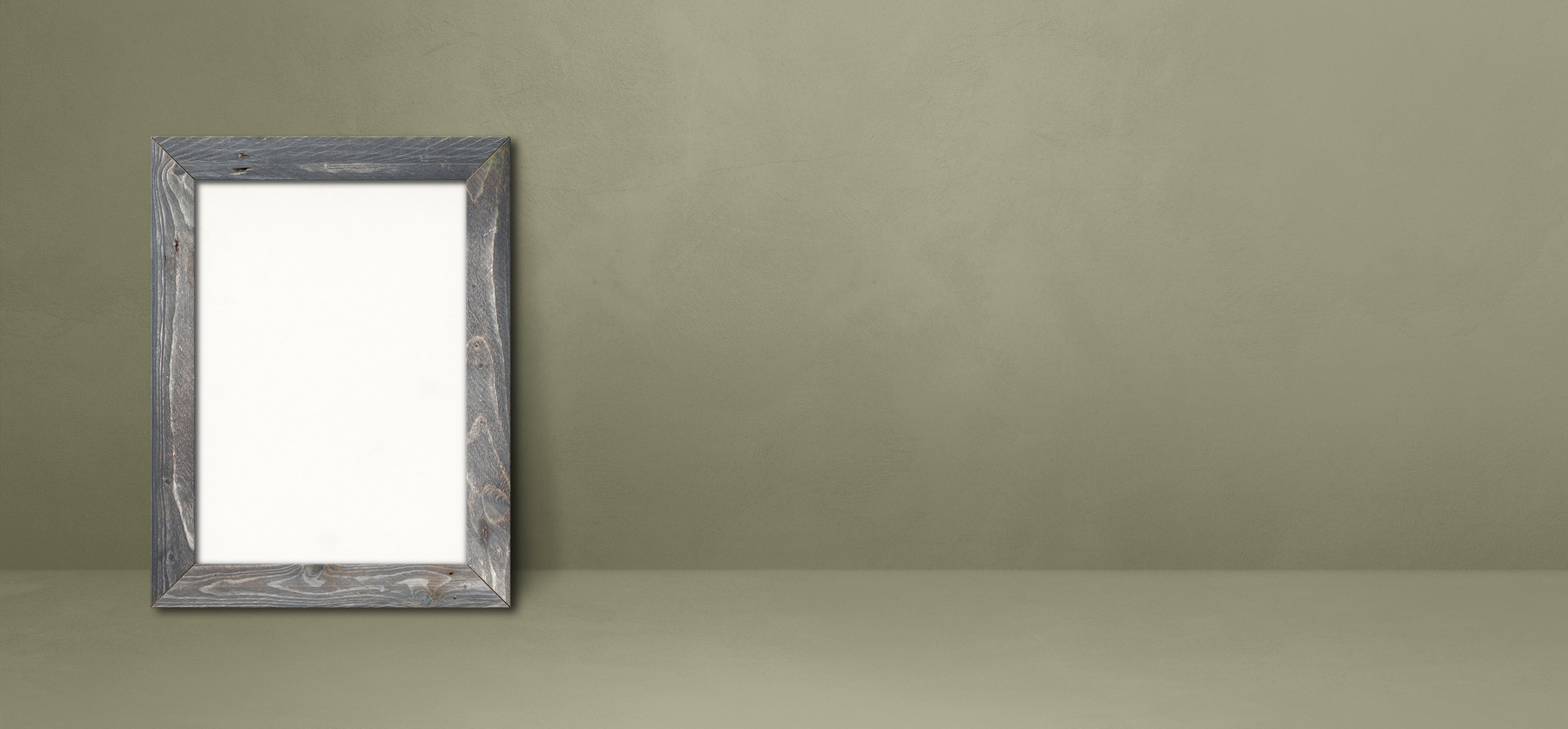 Wooden picture frame leaning on a grey wall. Horizontal banner, an ...