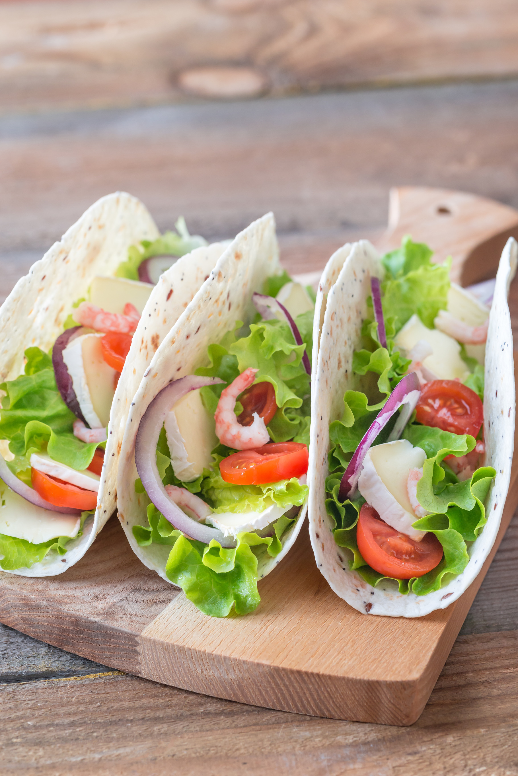 Tacos with shrimps and brie featuring background, board, and brie, a ...
