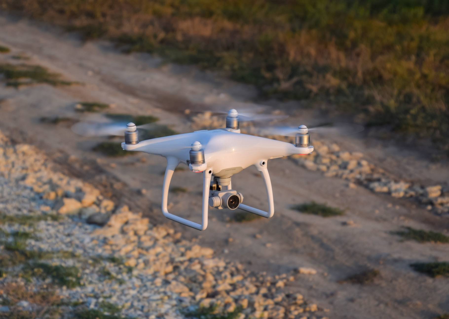 The drone hovering above the ground containing drone, field, and copter ...