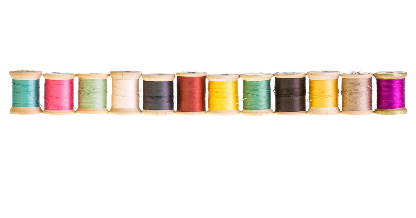 Row of thread spools on white, a Beauty & Fashion Photo by Zigzag ...