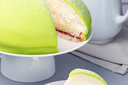 Slice of traditional Swedish dessert Princess cake with green marzipan ...