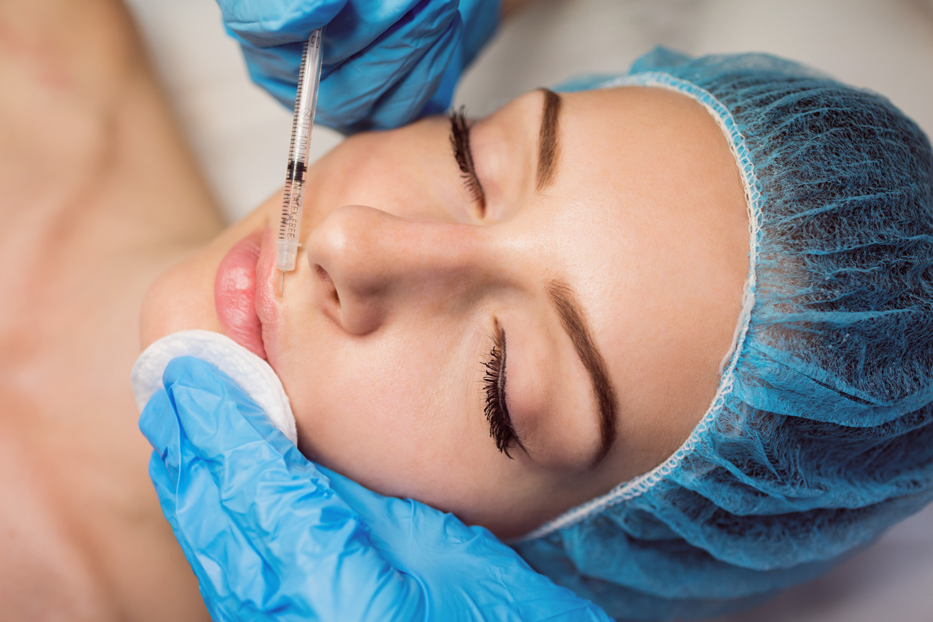 Female patient receiving an injection on her face, a Photo by ...