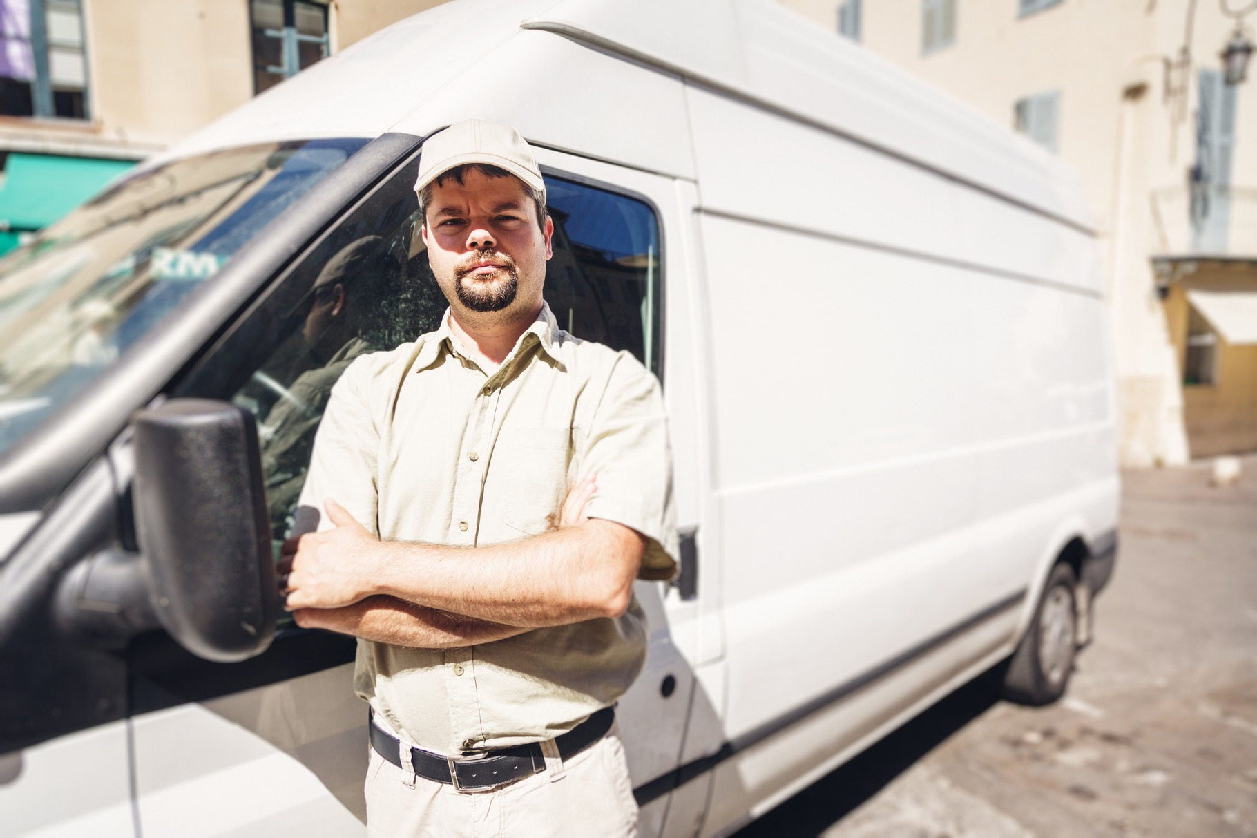 Messenger standing next to his van featuring delivering, delivery, and ...
