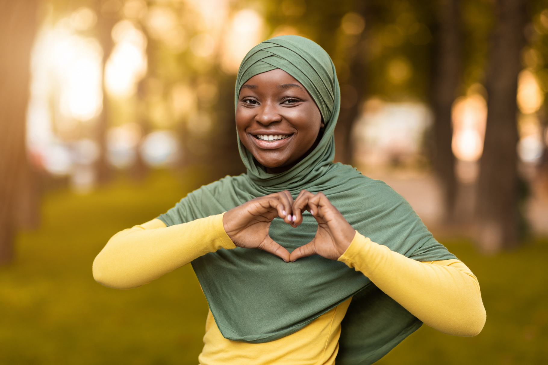 Love Concept. Smiling African Muslim Woman In Hijab Showing Heart ...