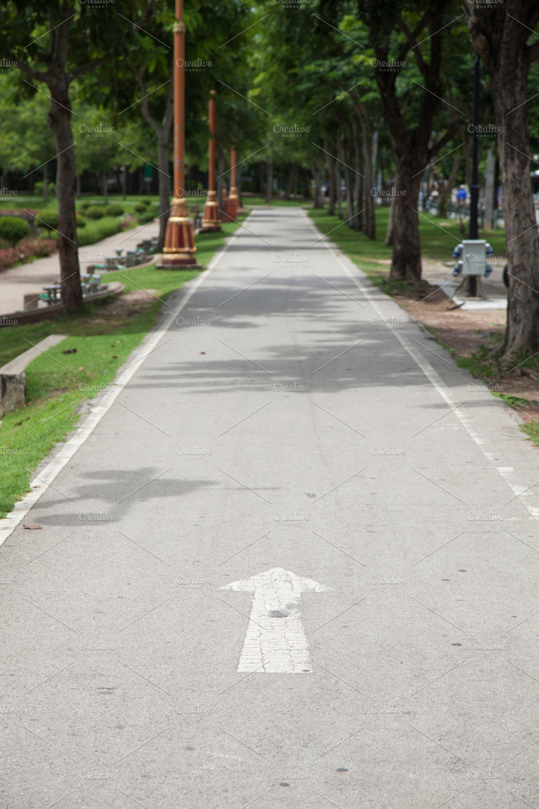 Directional arrow on the road containing road, arrow, and direction, a ...