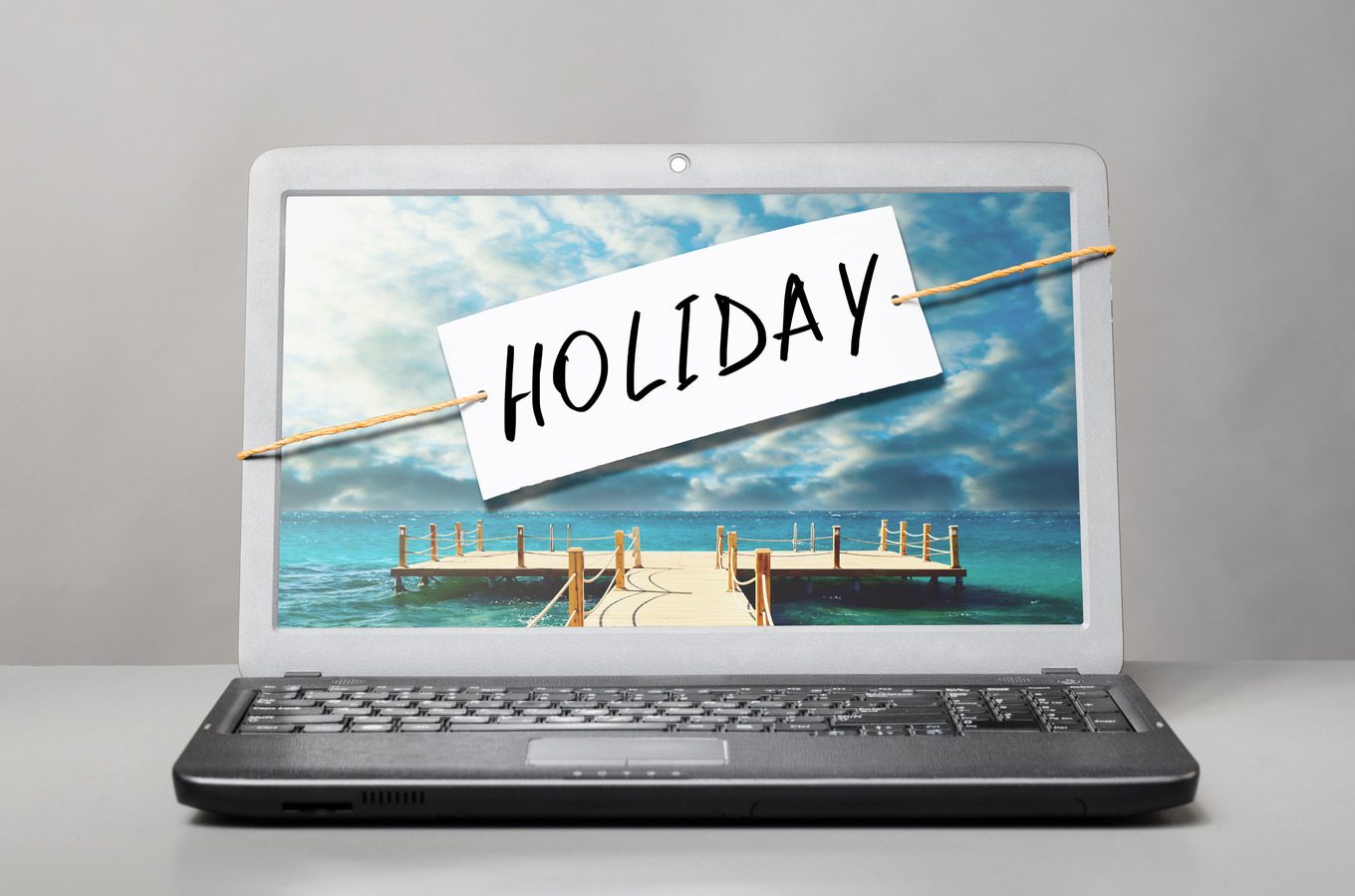 Laptop with holiday note featuring laptop, still life, and note, a ...