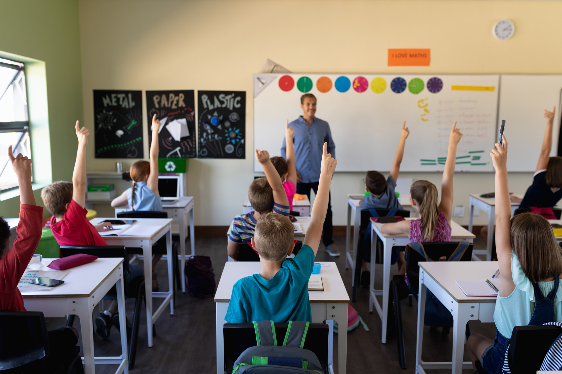 Teacher standing in a classroom, a Photo by wavebreak