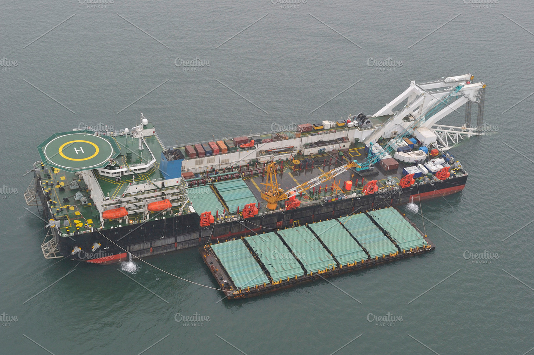 The pipelaying barge containing pipelayer, pipelay, and barge, an ...