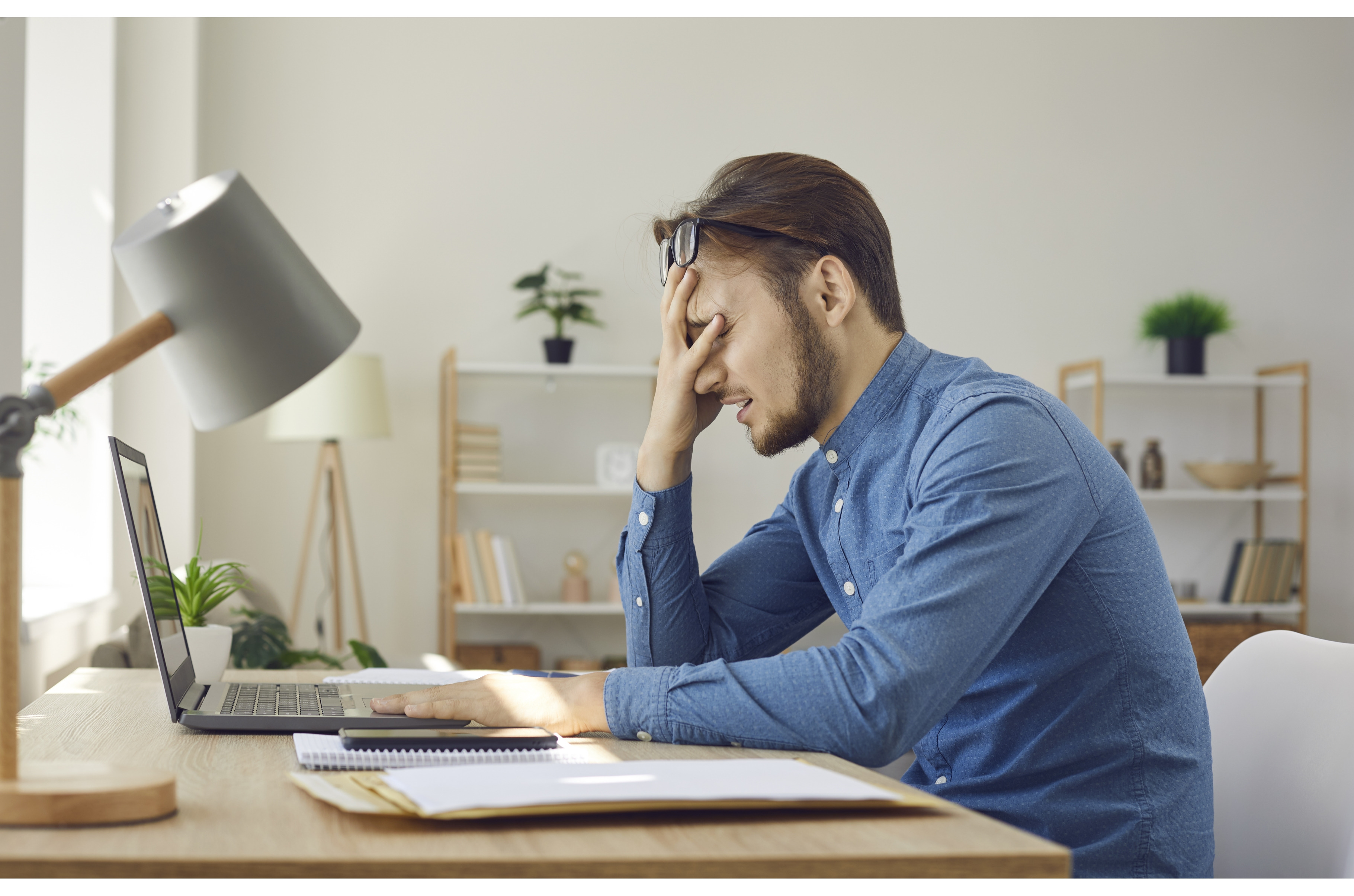 Tired stressed man sitting at desk, a Technology Photo by StudioRomantic