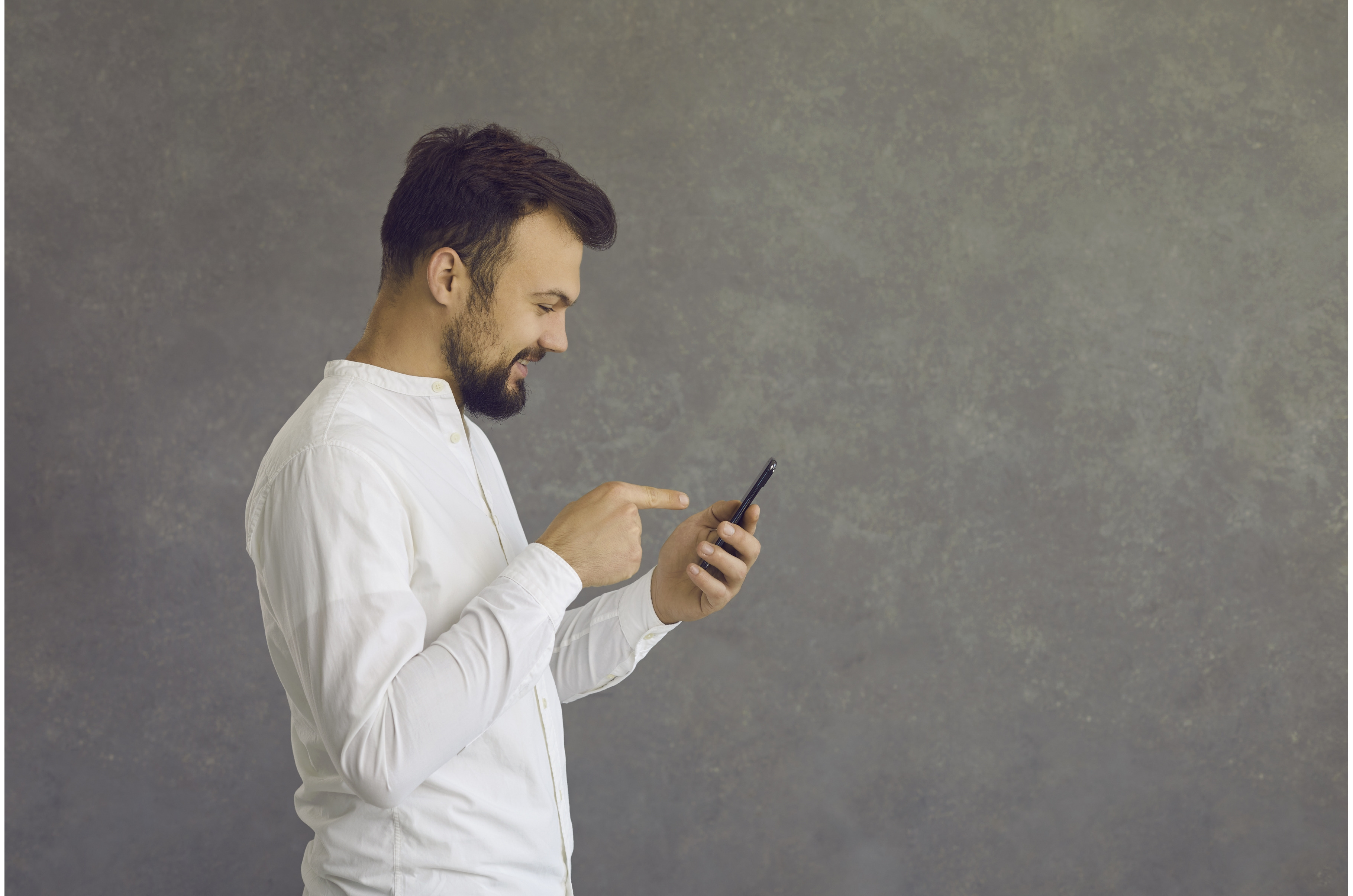 Side view of happy man using mobile, a Person Photo by StudioRomantic