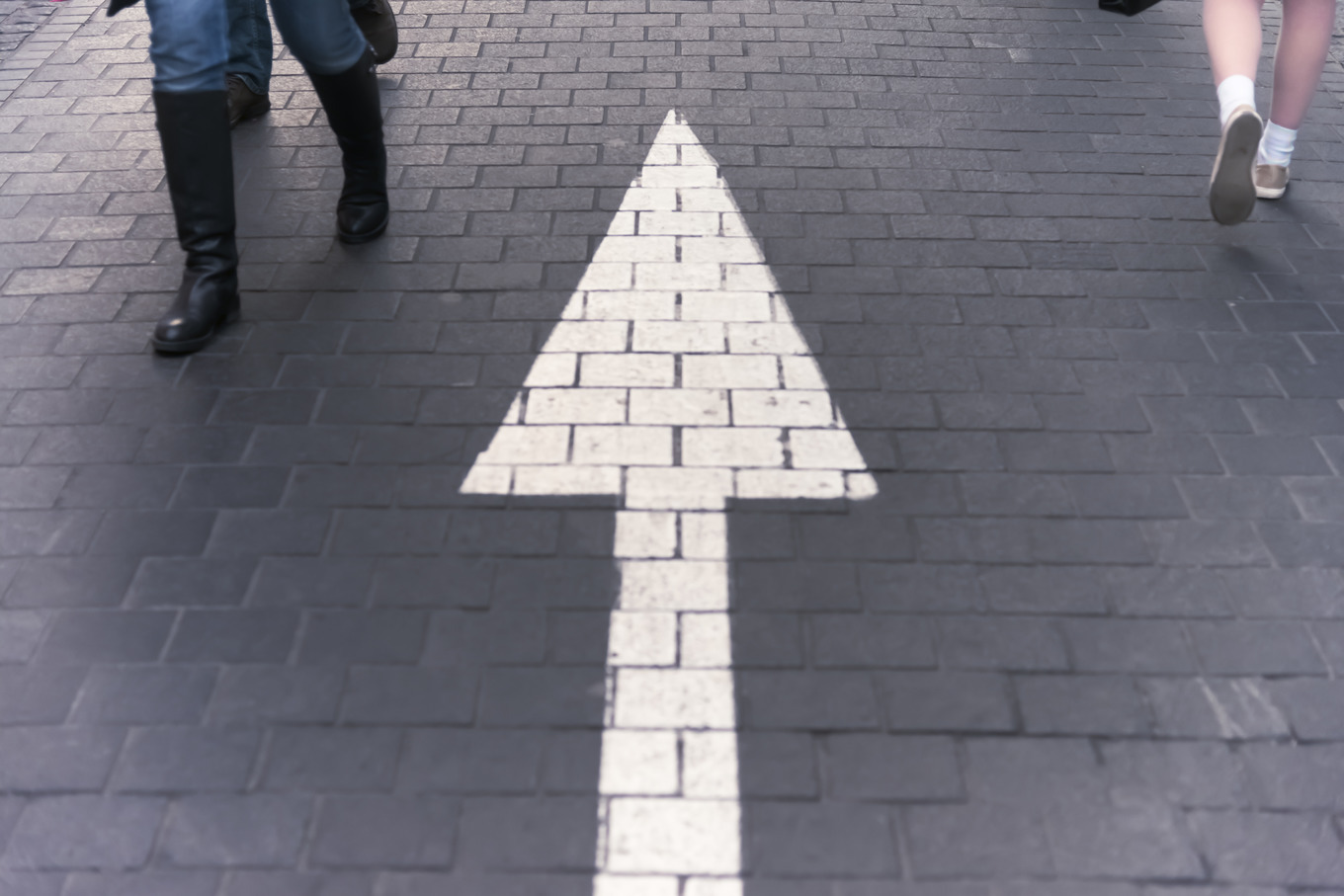 Arrow sign with people around, a Person Photo by PeoGeo Studio