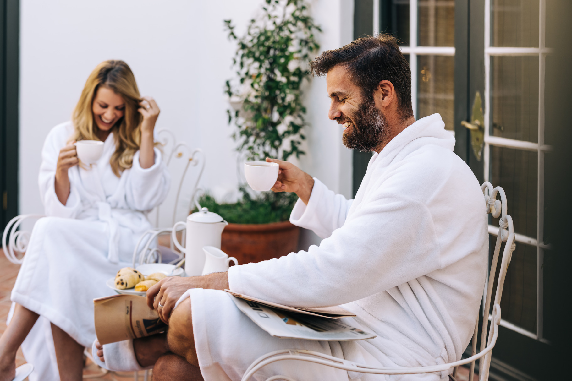 Cheerful married couple having tea in morning robes | People Images ...