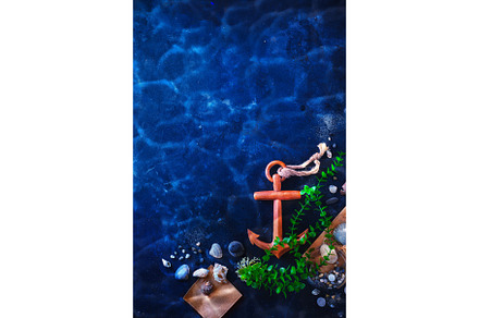 Marine copy space frame with message in a bottle, seashells, pebbles ...