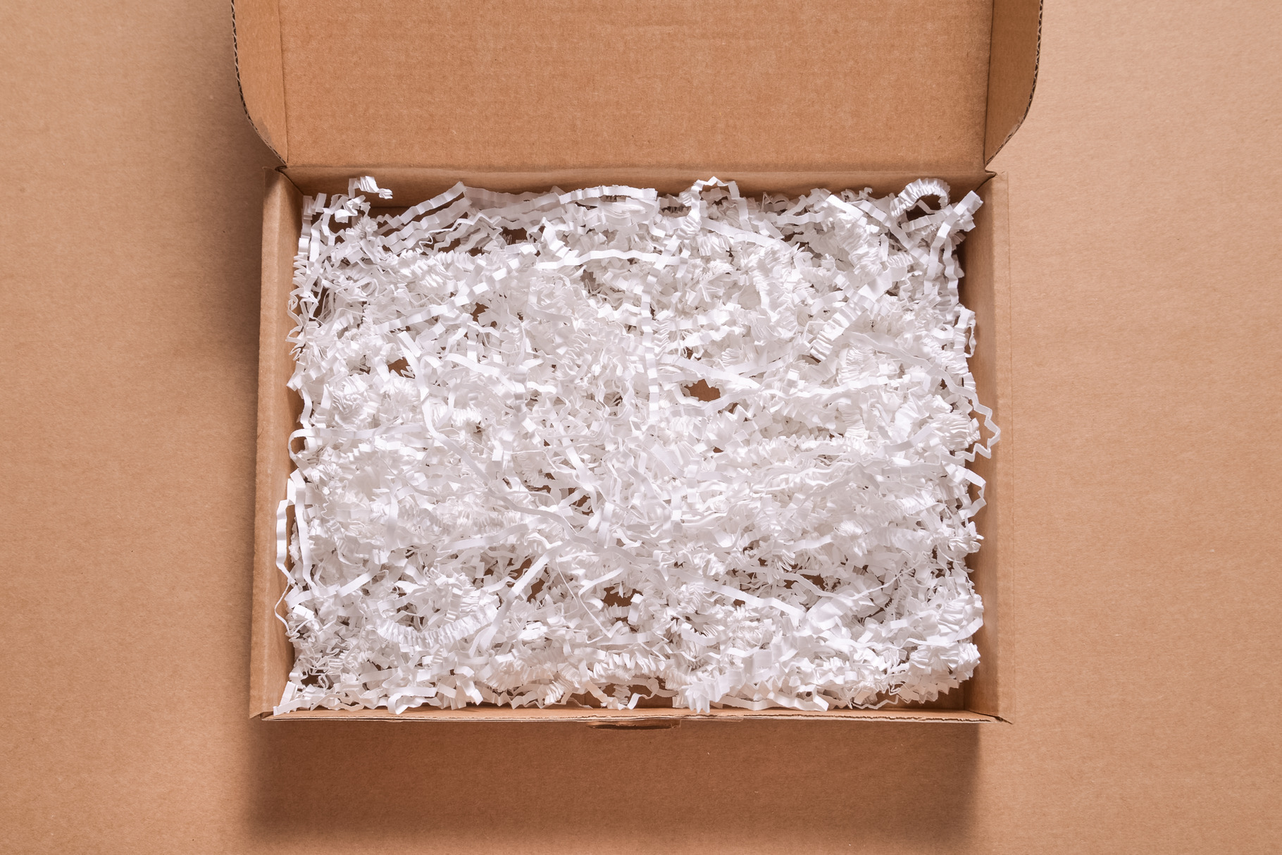 White paper filler in cardboard box featuring cut paper, background ...
