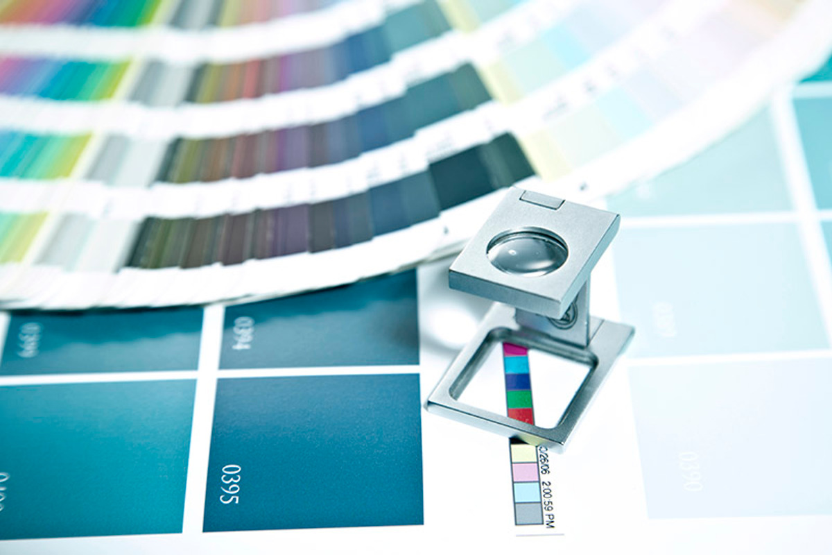 Print test sheet and pantone containing print, design, and offset, an ...