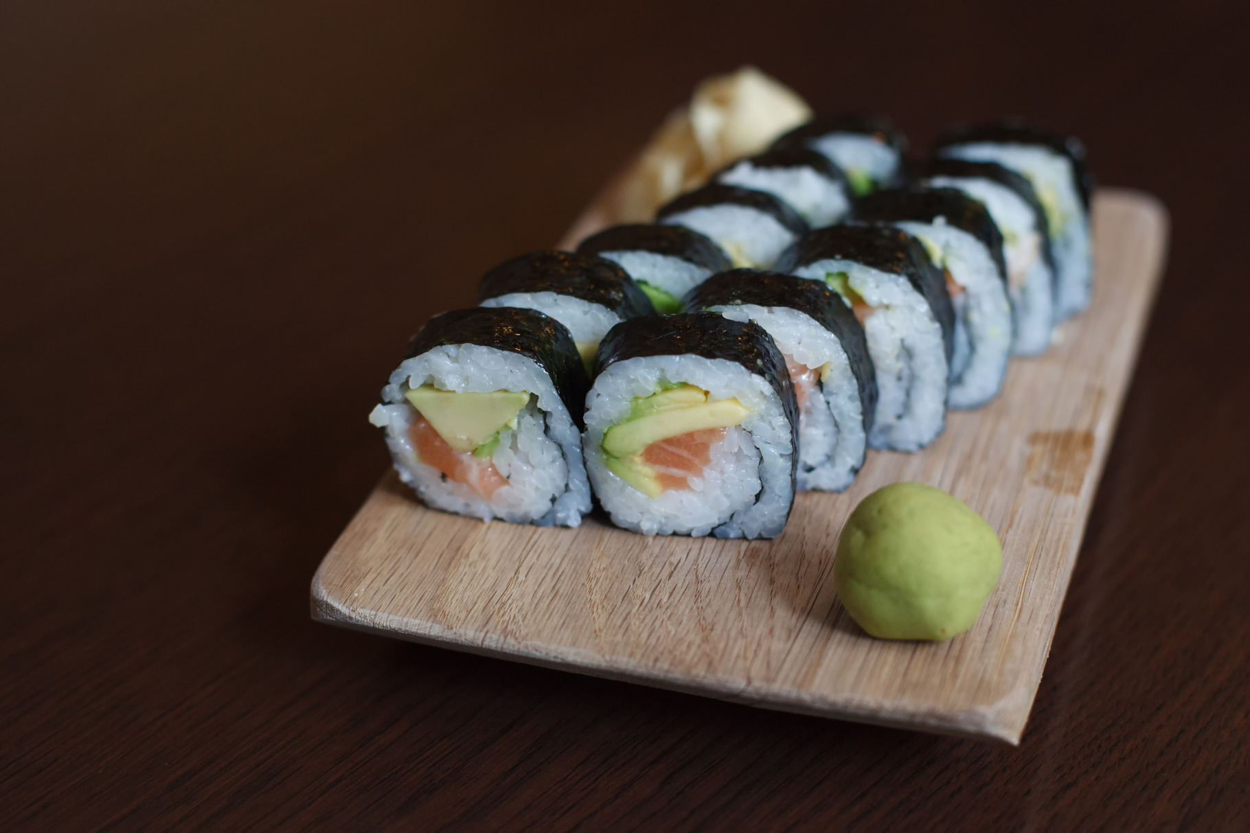 Sushi role on wooden board featuring role, appetizer, and fish, a Food ...