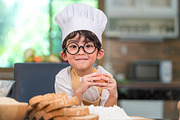 Portrait cute little Asian happy boy interested in cooking funny, a ...