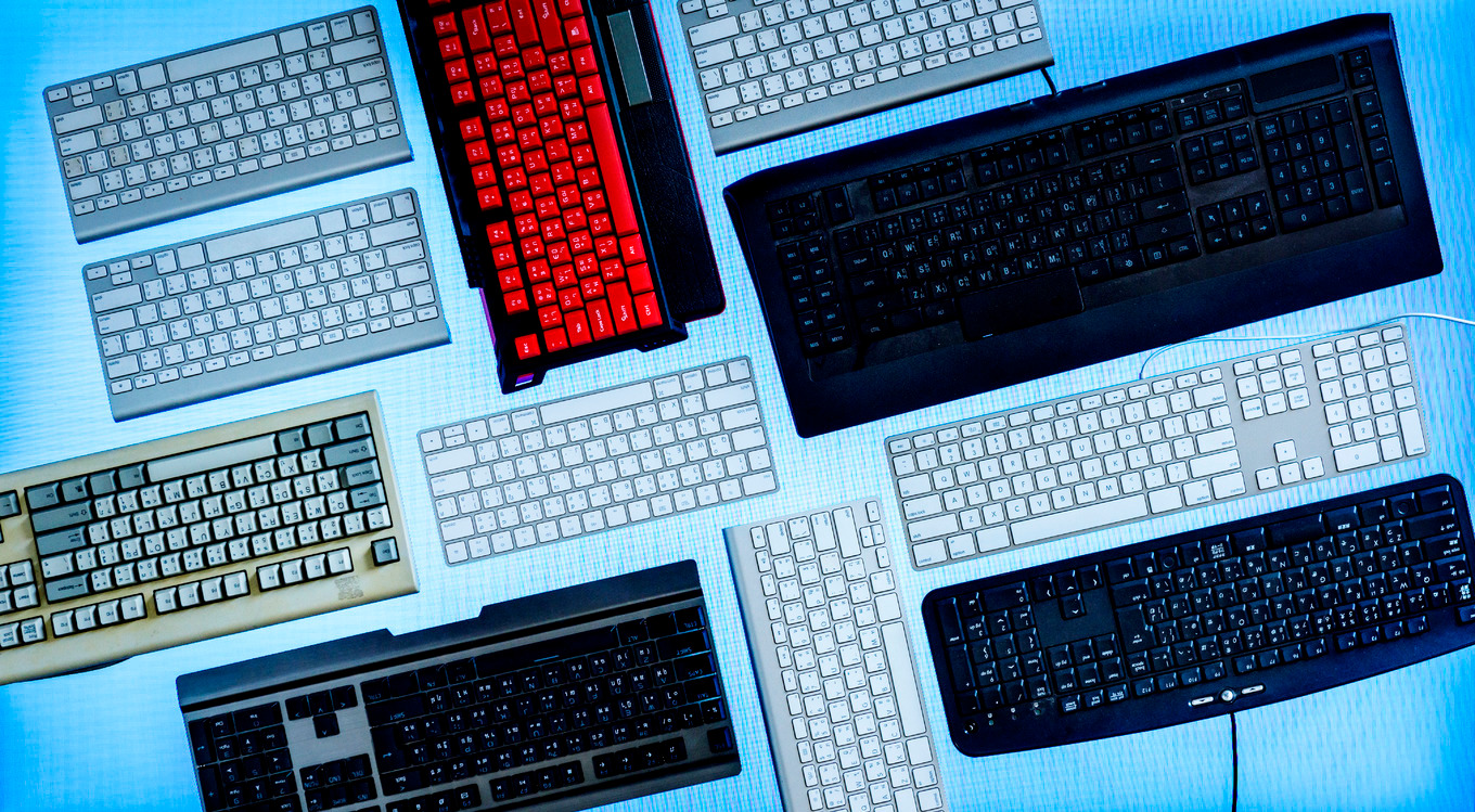 Computer keyboard featuring alphabet, button, and computer, a ...