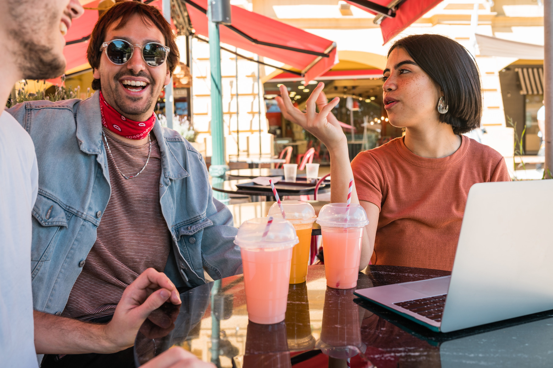 Young friends using laptop at coffee, a Photo by Mego-studio