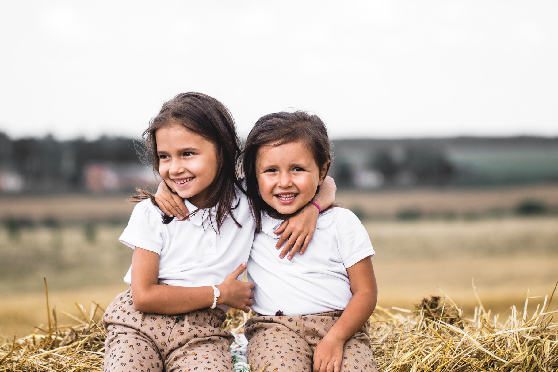 Happy children sit on the hay, a Person Photo by OS