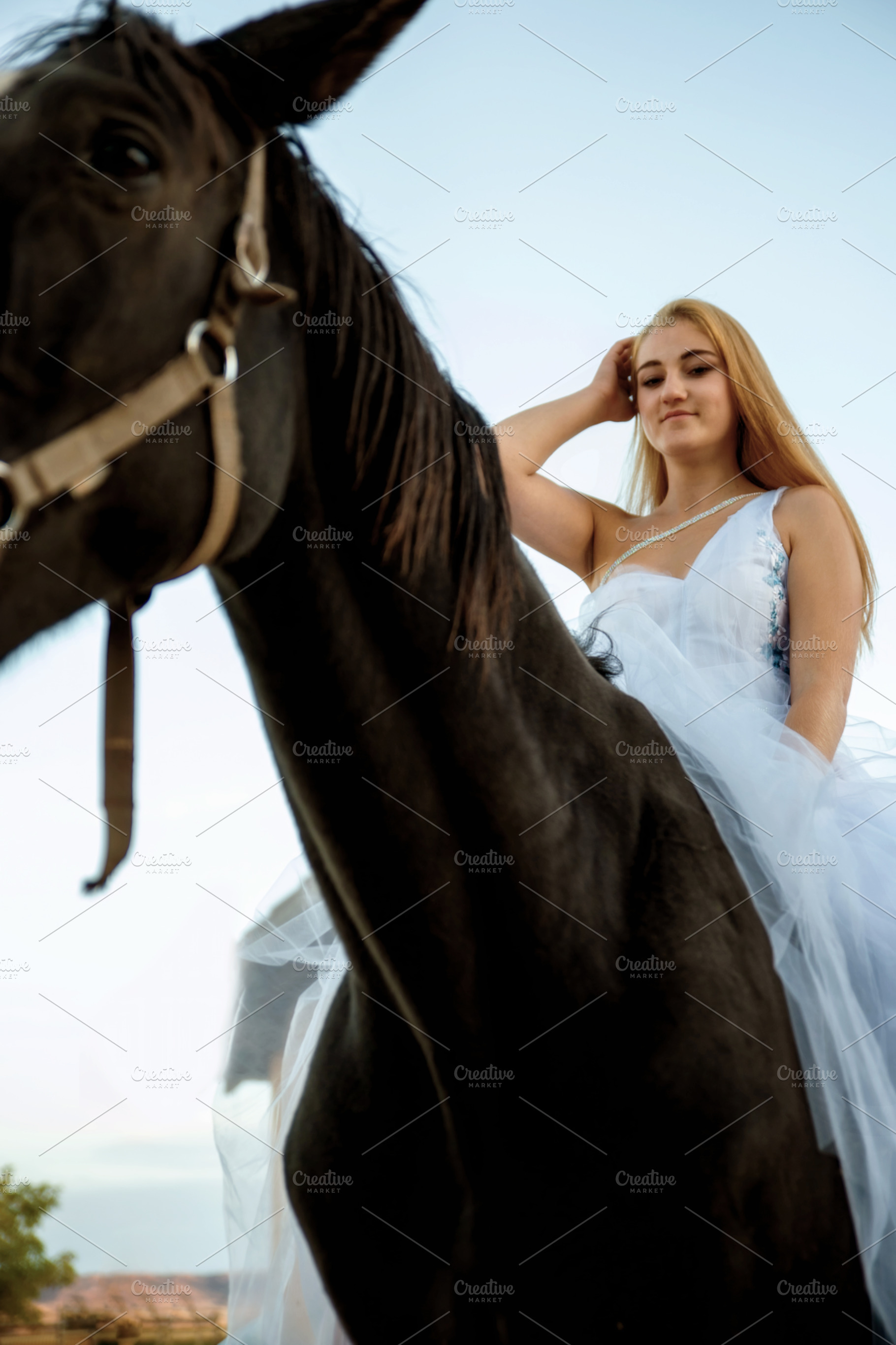blonde woman riding a horse, a Person Photo by Perpis | Creative Market