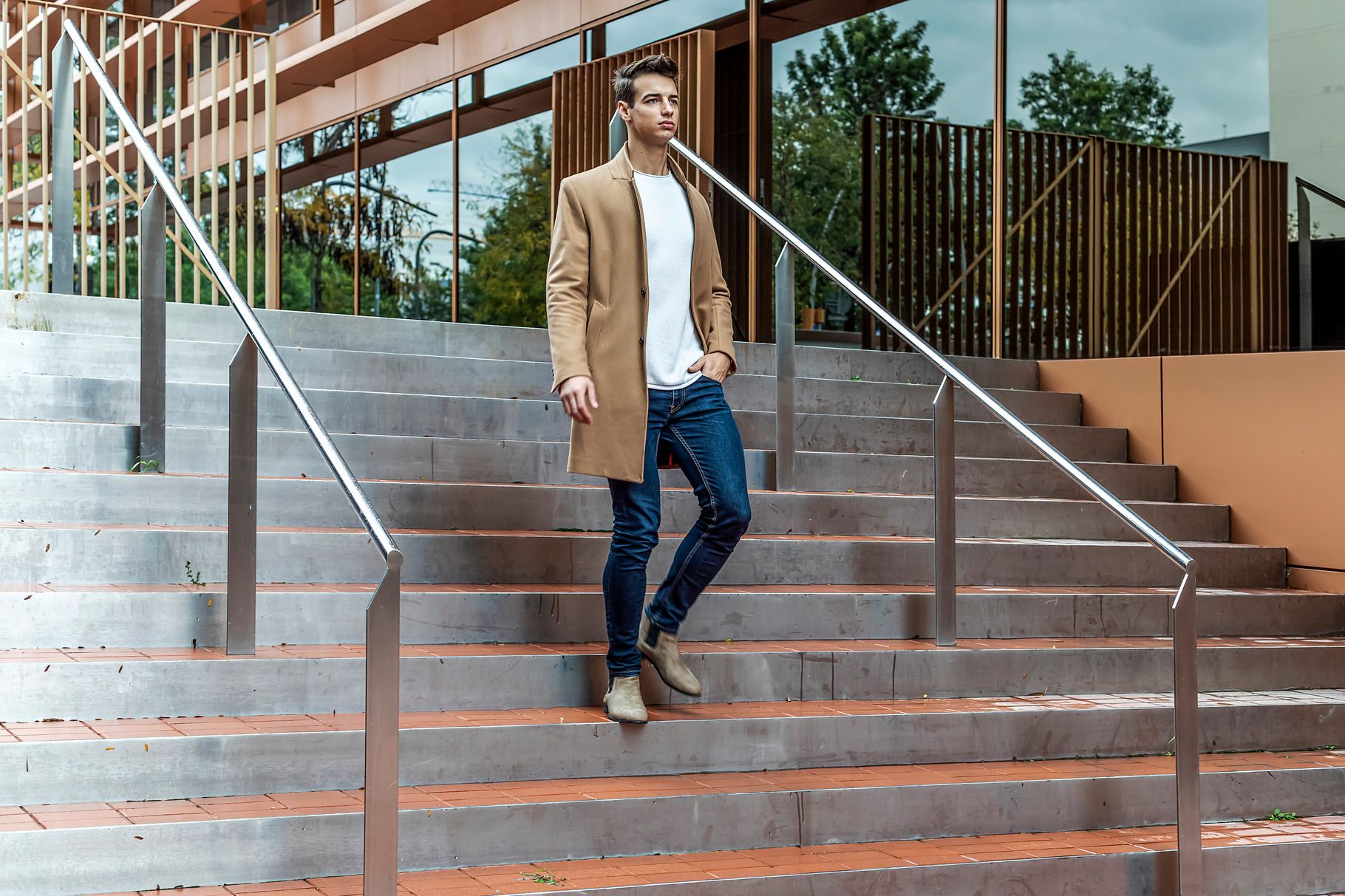 elegant and modern man walking down stairs of important building with ...
