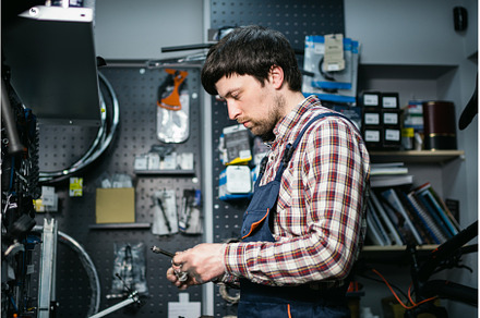 Young caucasian repairman repairing, an Industrial Photo by fotoliza