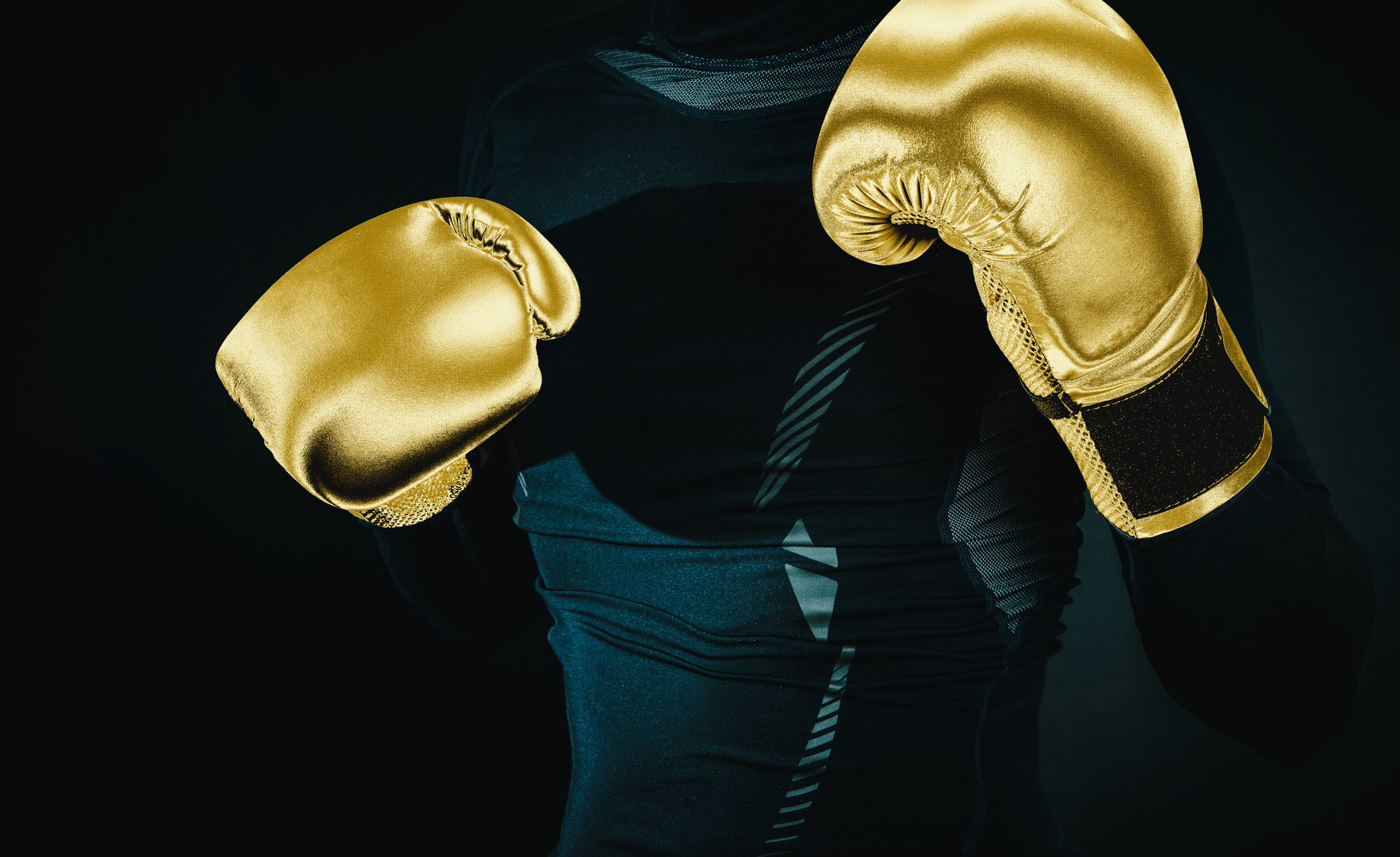 Boxer in gold boxing gloves, a Sports & Recreation Photo by BOKEHSTOCK