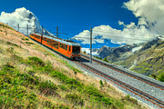 Electric tourist train in Zermatt, a Transportation Photo by Alpine Dreams