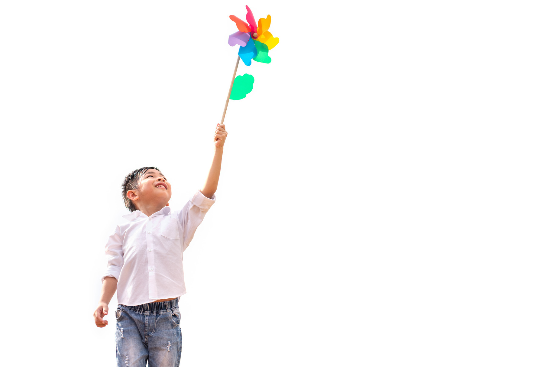 Boy holding colorful pinwheel in windy at outdoors. Children por, a ...