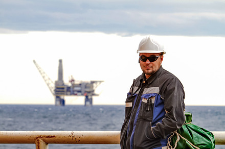 Oilman shift workers on the deck of the ship on the background offshore ...