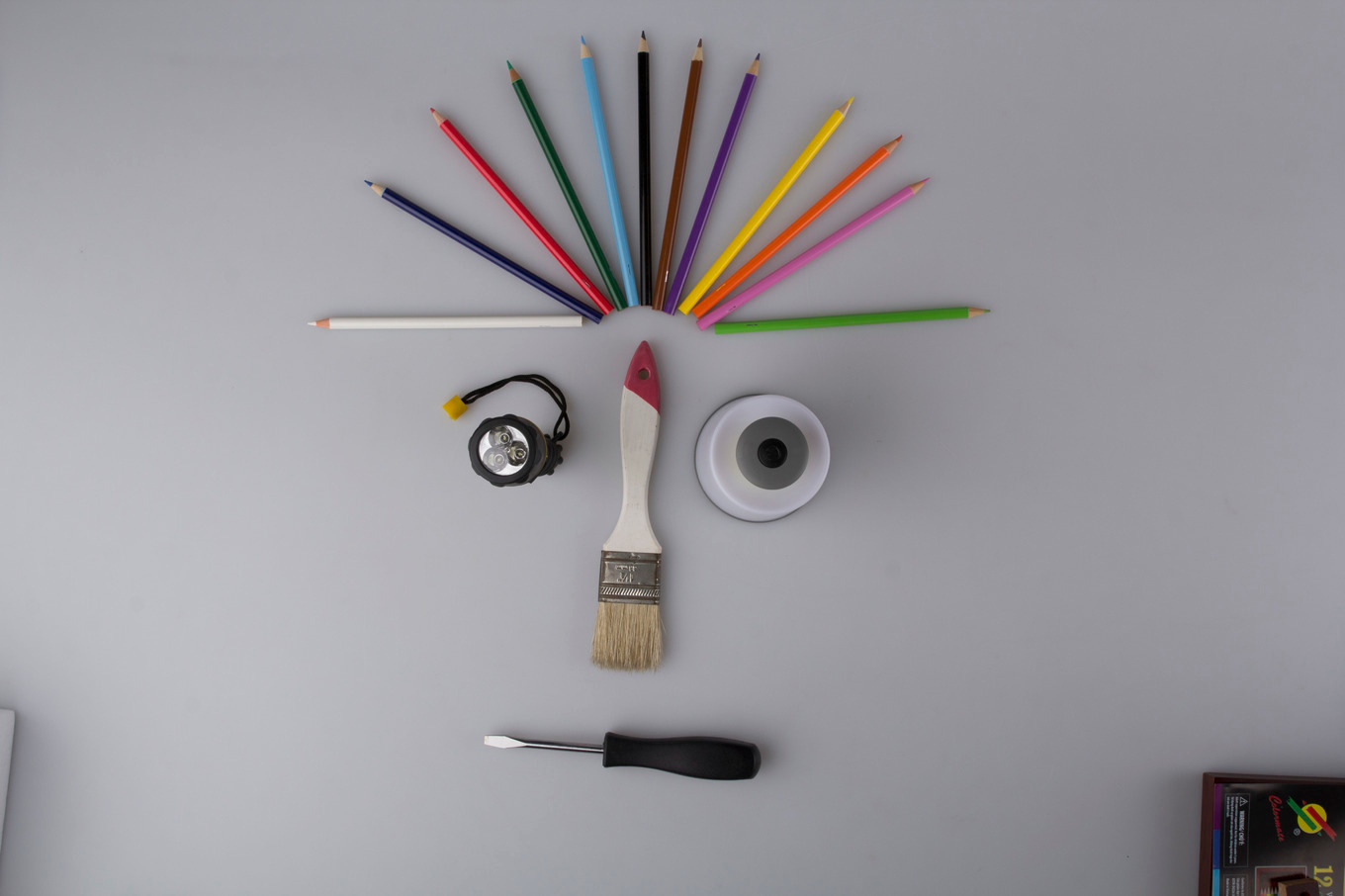 Desk of an artist with lots stationery objects studio shot on white, a ...