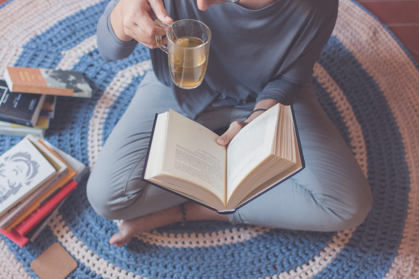 Reading and drinking tea, a Person Photo by Tan Tranquila