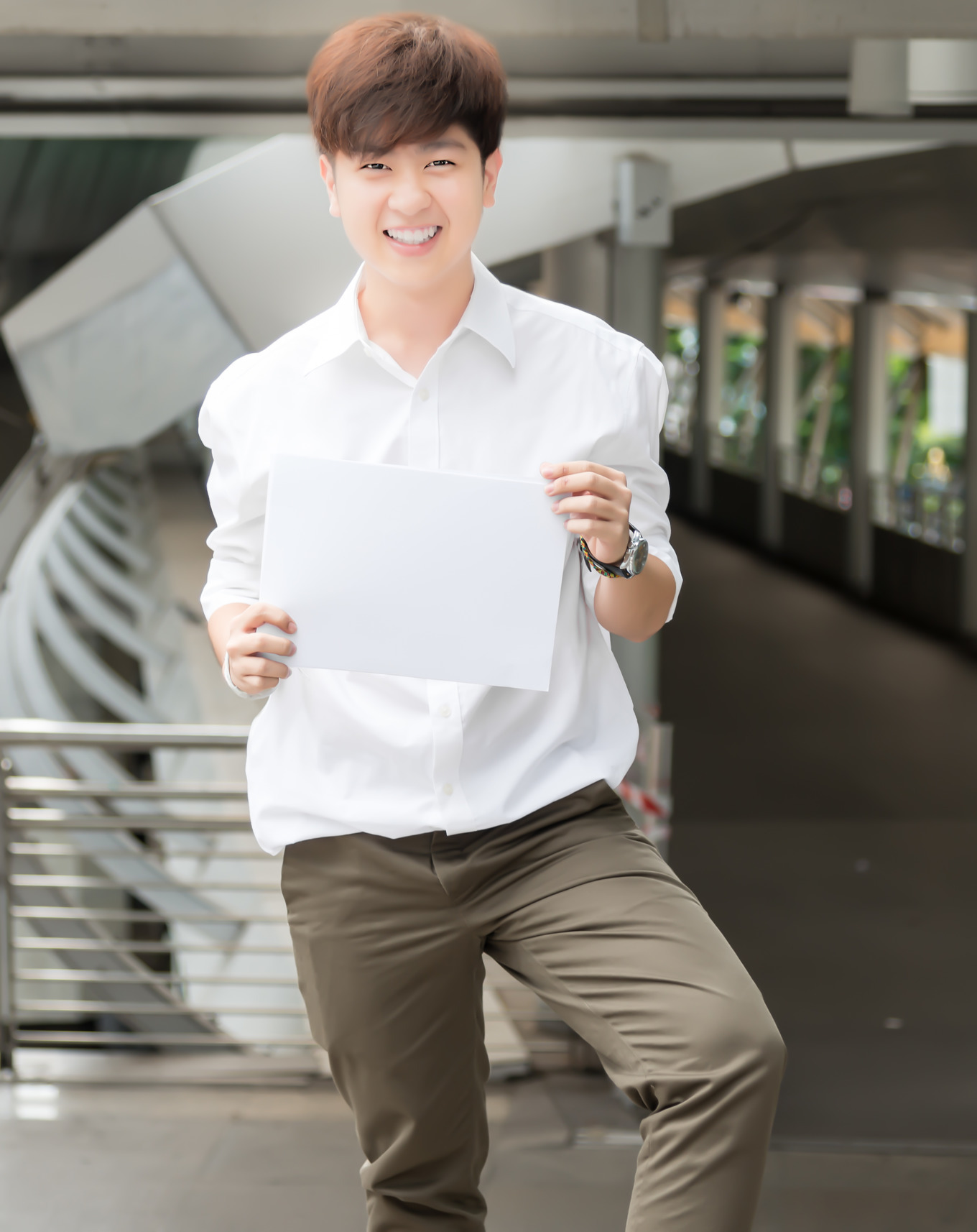 Handsome boy hold white paper, a Background Photo by PeoGeo Studio