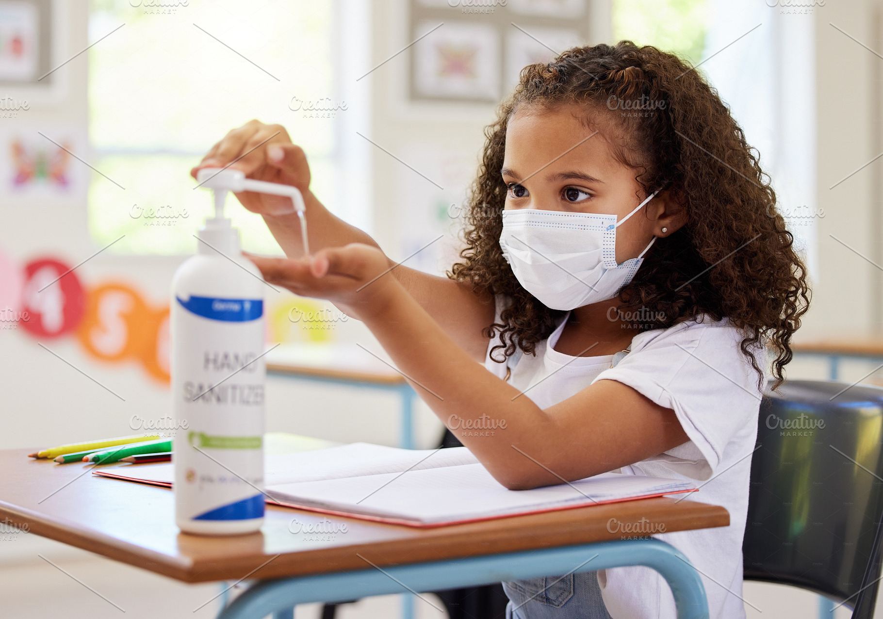 School kid using hand sanitizer for germ protection, hygiene and ...