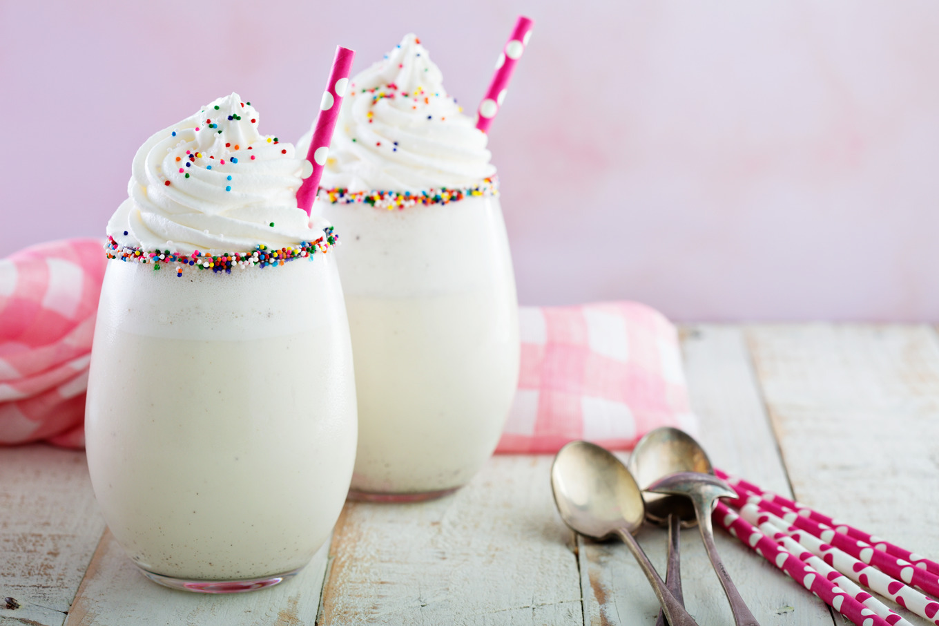 Vanilla milkshake with whipped cream and sprinkles featuring vanilla, a ...