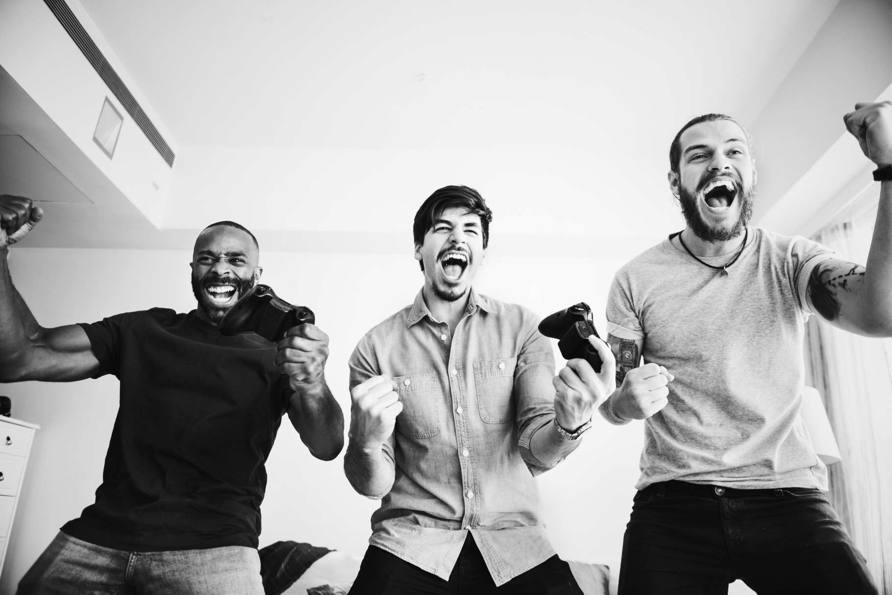 Friends playing video game together, a Photo by rawpixel