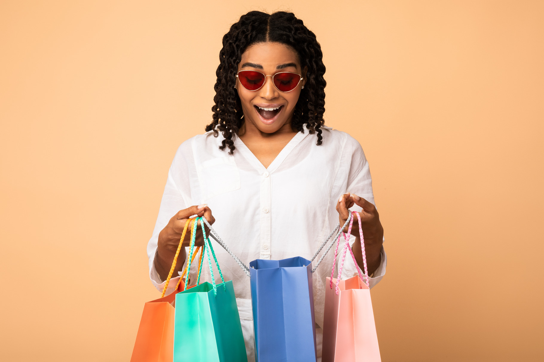 Joyful African Woman Holding Shopper, a Background Photo by Prostock-Studio