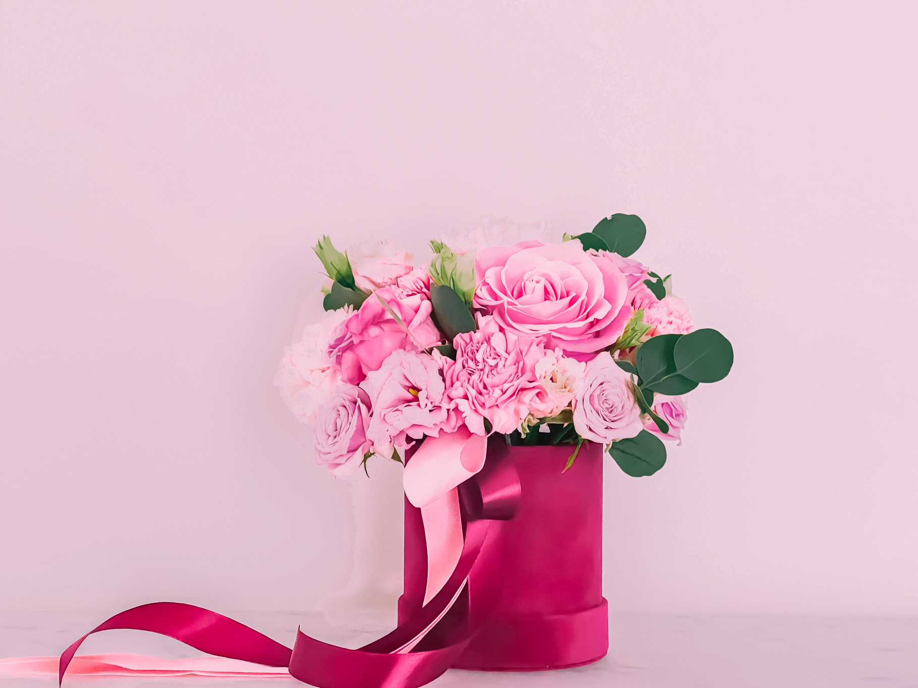 Beautiful bouquet of blooming flowers in flower box on pink back, a ...