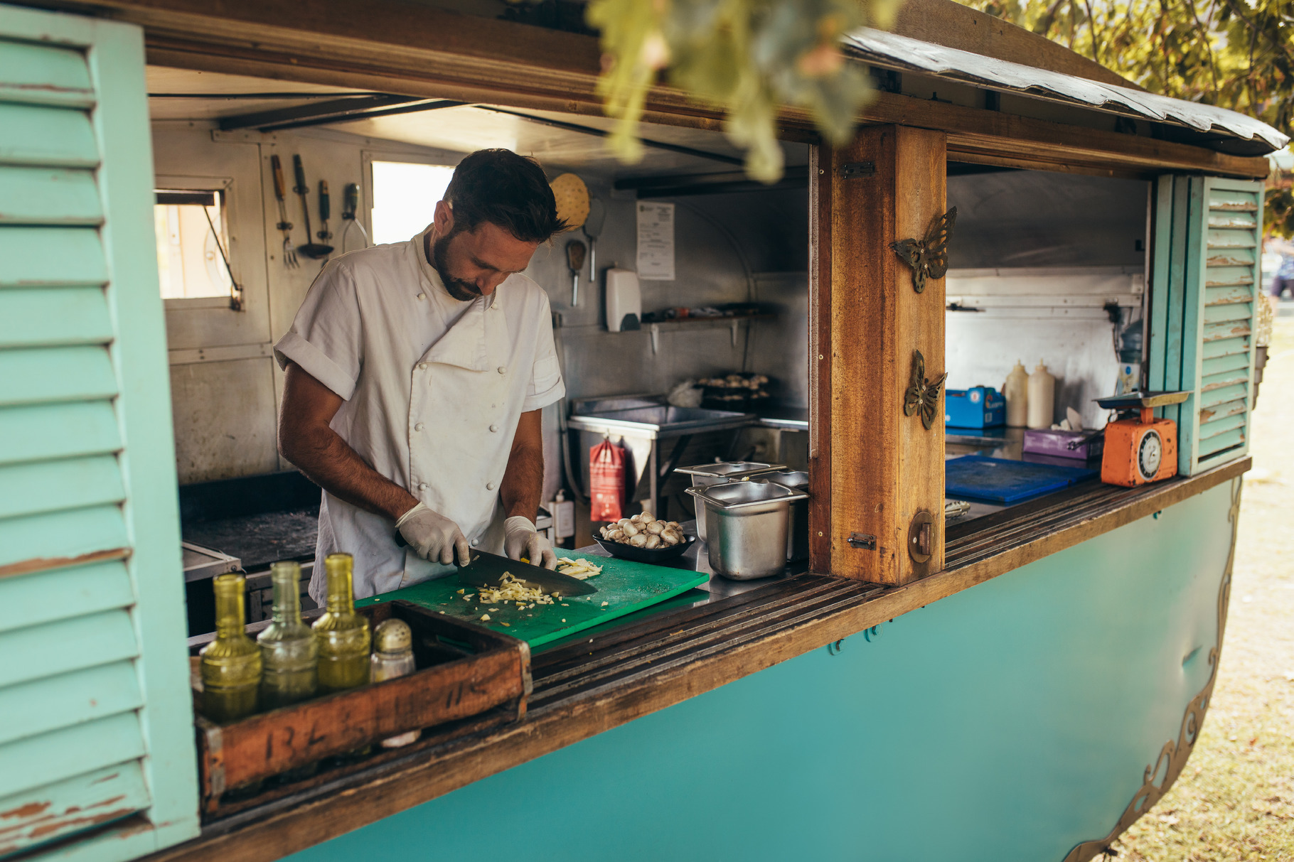 Man cooking in a mobile food truck | People Images ~ Creative Market