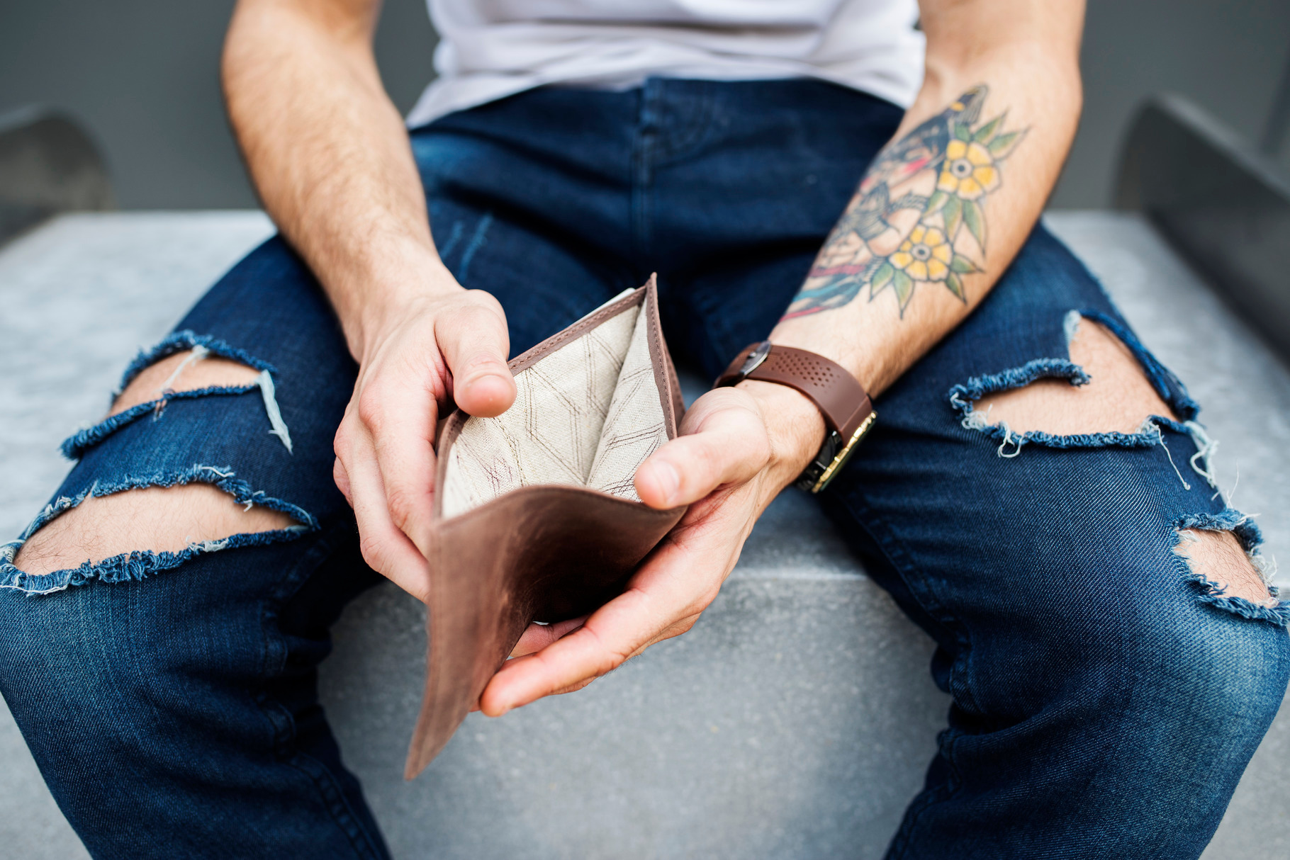 Arm with tattoo holding empty wallet featuring alone, american, and ...