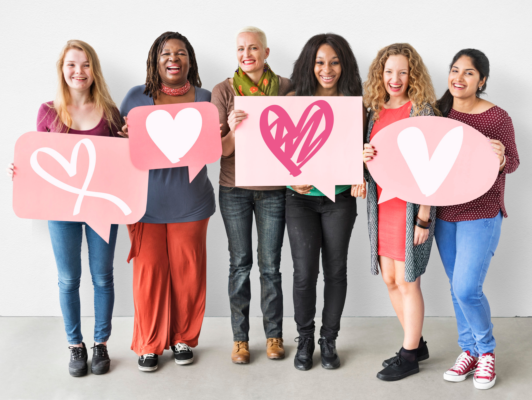 Group of women holding heart icons, a Photo by rawpixel