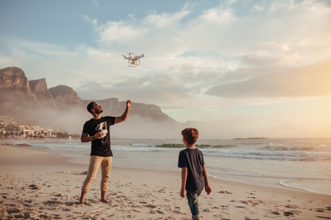 Father and son operating drone, a Person Photo by Jacob Lund