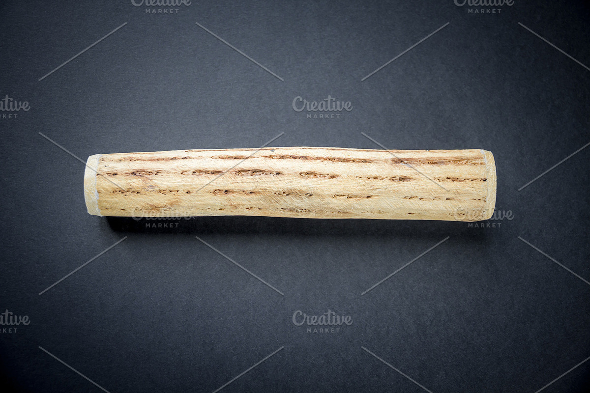 Traditional rain stick made of cactus wood isolated on black, an Object ...