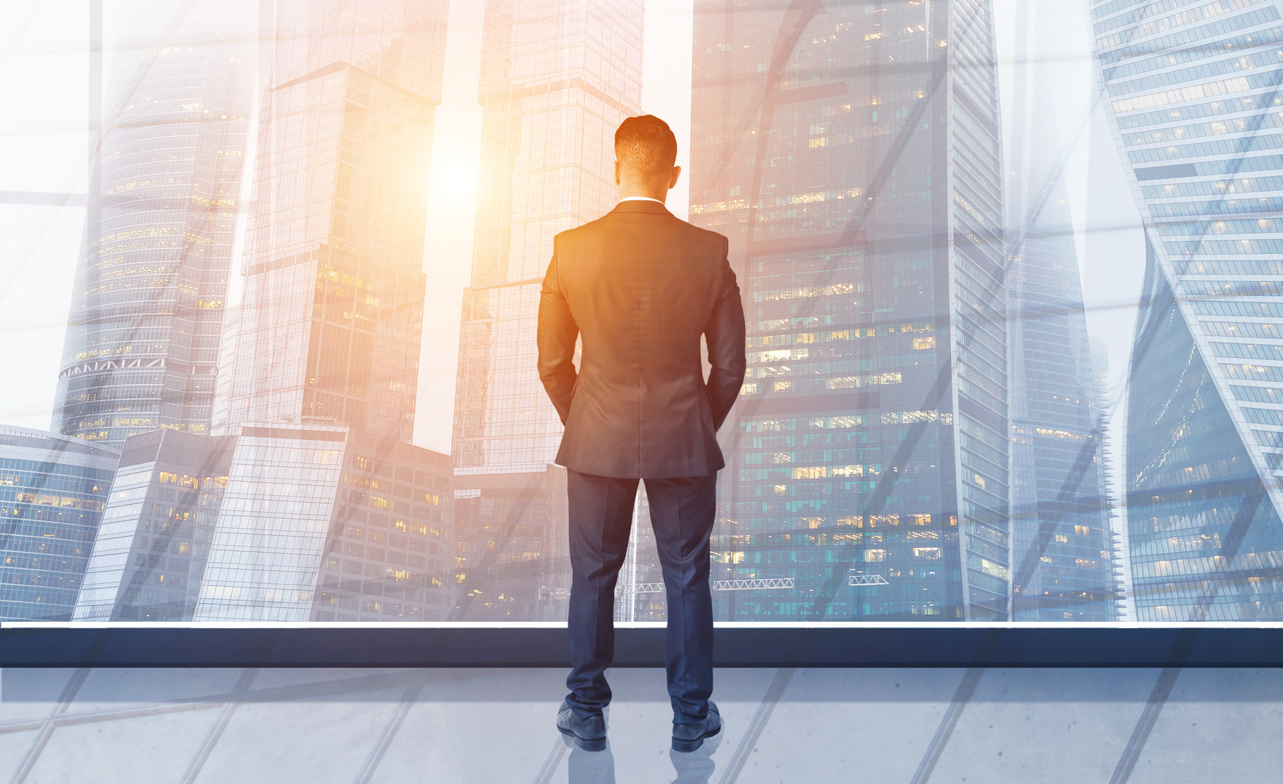 Rear view of businessman looking out, a Background Photo by Prostock-Studio