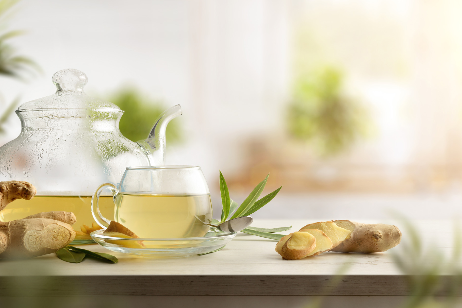 Cup with ginger drink on bench with teapot in kitchen, a Food & Drink ...