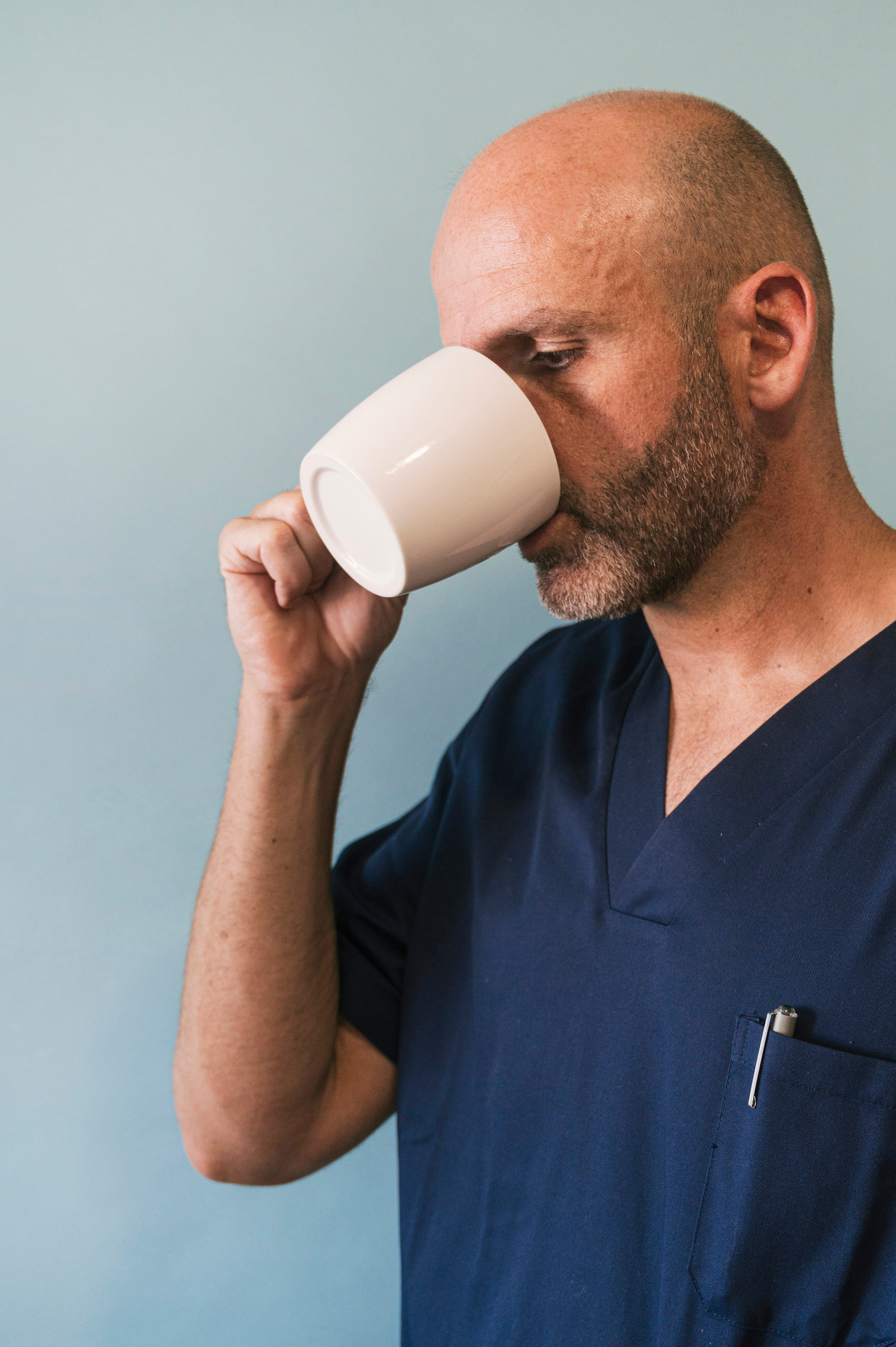 Studio portrait of doctor drinking coffee, healthcare worker, a Person ...